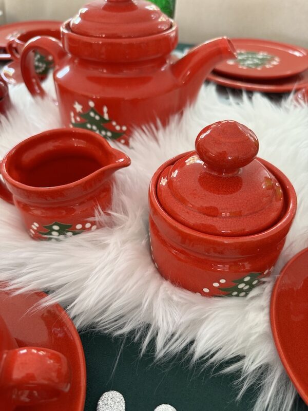 A German Christmas Tablescape set with beautiful red stoneware.